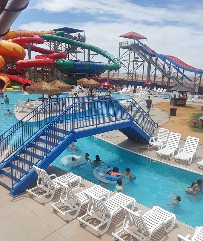 That blue bridge arching over crystal water is your gateway to the lazy river of your dreams.