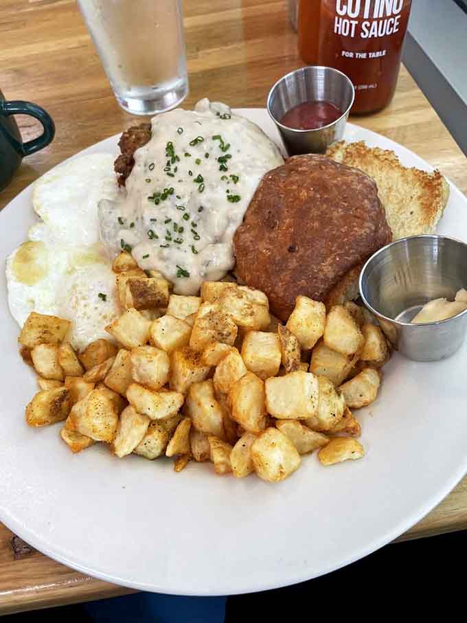 Chicken fried steak smothered in gravy with hash browns is the breakfast that built America, one delicious bite at a time.