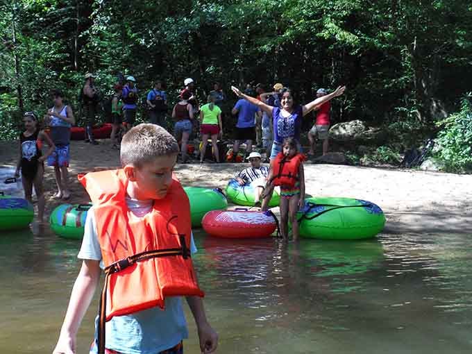 Young adventurers gearing up for their river journey, life jackets on and excitement levels maxed out completely.