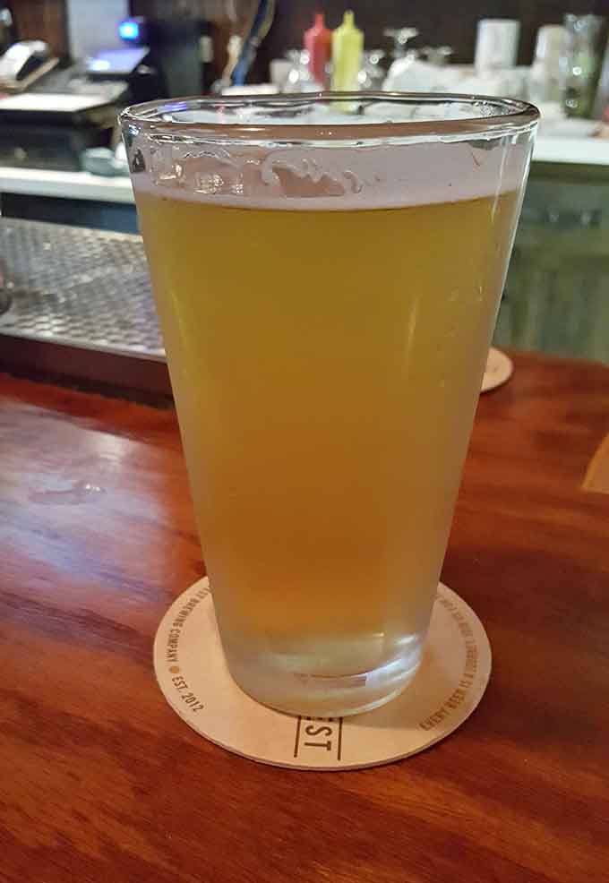 A cold beer on a wooden bar is the perfect companion for tackling one of those massive burgers.