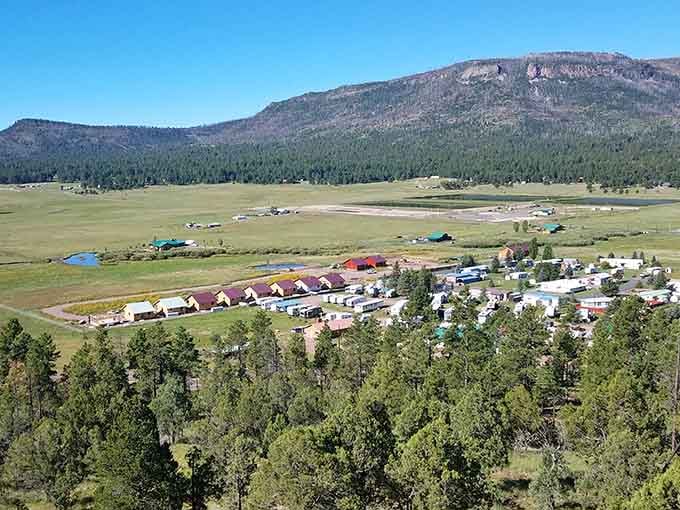 This valley cradles a small town where mountains stand guard and meadows stretch toward endless horizons.