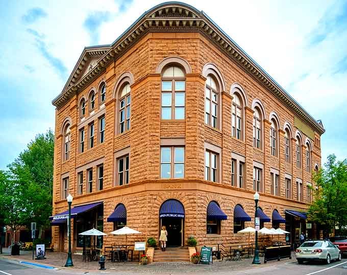 That gorgeous brick corner building with blue awnings has been welcoming visitors since the Victorian era began.