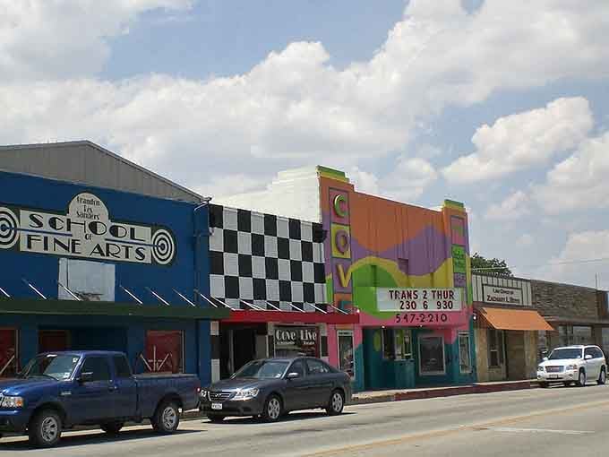 That Art Deco theater facade stands like a beacon on a street where entertainment doesn't require expensive tickets.