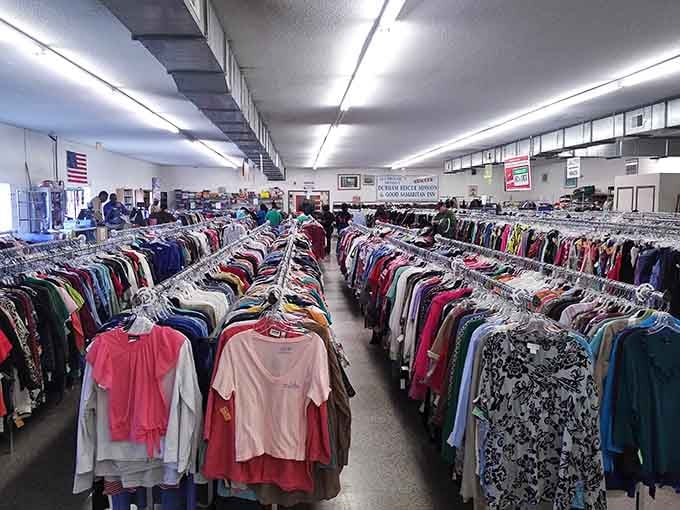 Clothing racks march in perfect formation under bright lights, making size-hunting easier than finding Waldo in stripes.