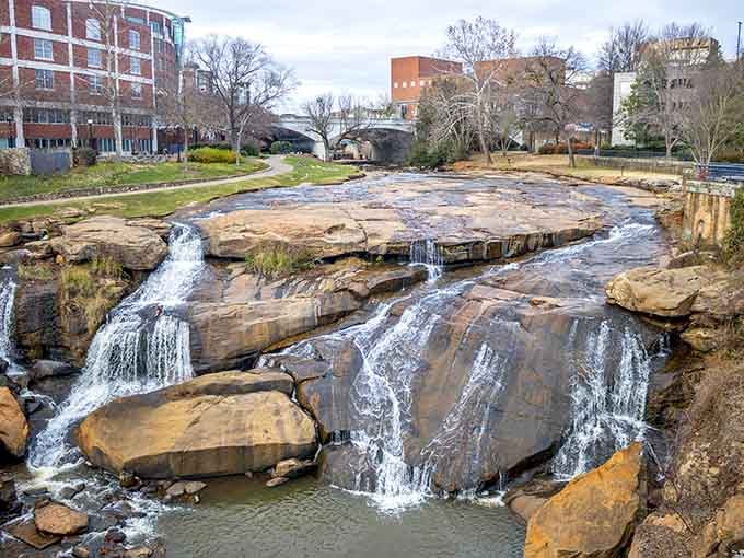 Downtown waterfalls cascade over ancient rocks, proving that cities and nature can absolutely share the same zip code.