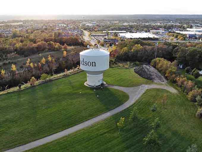 Hudson's water tower rises above autumn trees like a lighthouse guiding travelers to this riverside gem of a town.