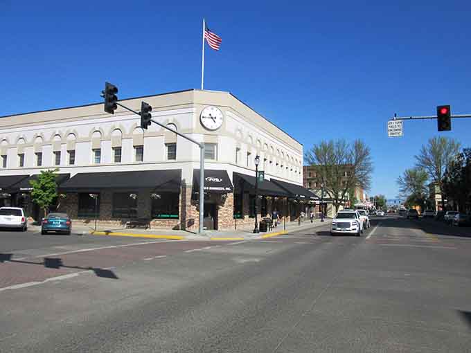 That dignified white building anchors downtown with timeless elegance while the American flag waves proudly overhead in crisp air.