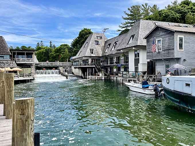 Weathered boathouses line the harbor where working vessels bob gently, reminding us of honest maritime traditions.