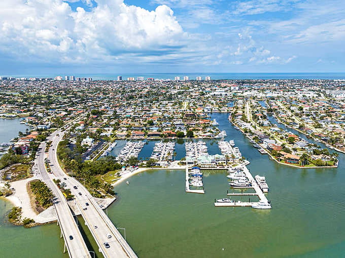 Boats dot the marina like toys in a bathtub, surrounded by neighborhoods where waterfront living is the norm.