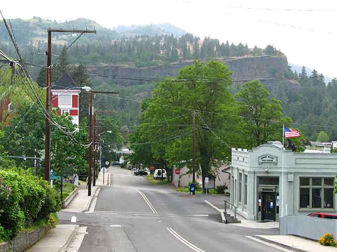Dramatic cliffs rise behind town like a movie backdrop, making every morning coffee feel like an adventure film.
