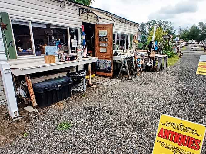 That bright yellow "ANTIQUES" sign catches your eye immediately, pointing the way to decades of accumulated wonderful stuff.