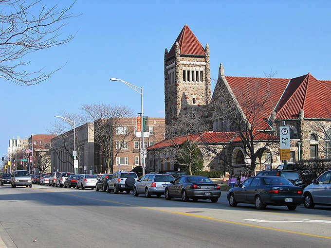 That stone church tower with its red tile roof stands like a castle keep, adding European architectural drama to the streetscape.