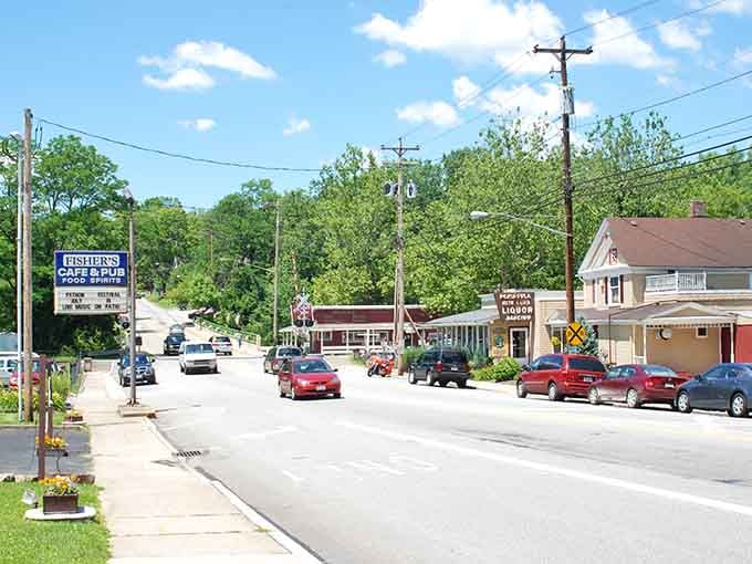 Tree-lined streets slope gently toward forested hills, framing this town like nature's own perfect picture postcard.
