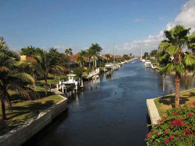 Boats line the canal like a nautical neighborhood where waterfront living means your backyard connects to endless exploration possibilities.