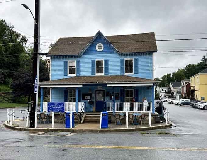 The bright blue exterior on this rainy day shines like a sapphire, promising warmth and comfort inside.