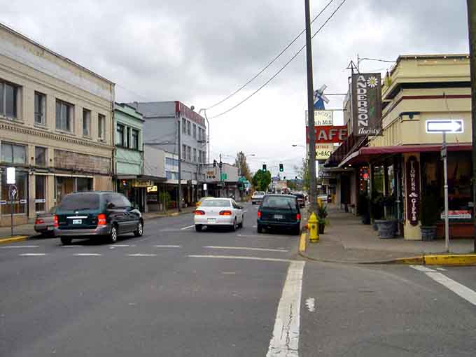 Historic downtown buildings stand shoulder to shoulder, their facades weathered by salt air and time into authentic coastal character that can't be faked.