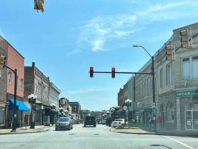 Main Street stretching into the distance with classic storefronts that haven't forgotten what community actually means to people.