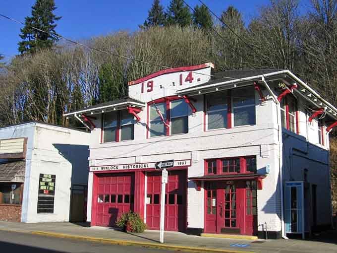 Bright red doors on this vintage fire station pop against white walls like a candy cane, preserving firefighting history with style.