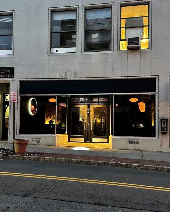 The sleek black facade at dusk glows like a modern art gallery, but inside they're creating edible masterpieces.