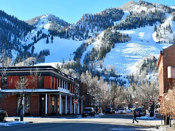 Snow blankets the slopes above town where ski runs carve white ribbons down the mountainside all winter long.