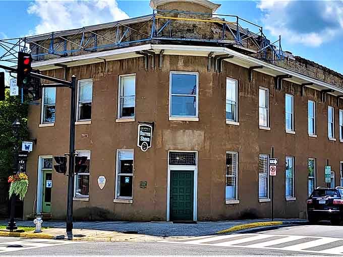 This corner building wears its age like a badge of honor, patina and all, standing guard over quiet intersections.
