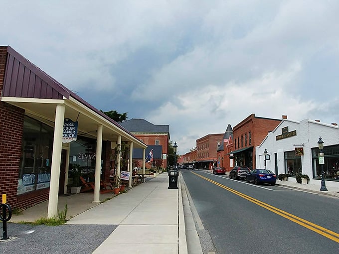 Storm clouds gather over shops and sidewalks, but the town's charm shines through like sunshine breaking between the gray.