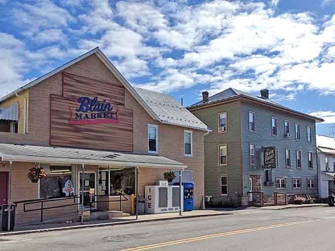 Butler's Market welcomes shoppers under dramatic clouds, offering small-town commerce with character that big-box stores will never understand or replicate.