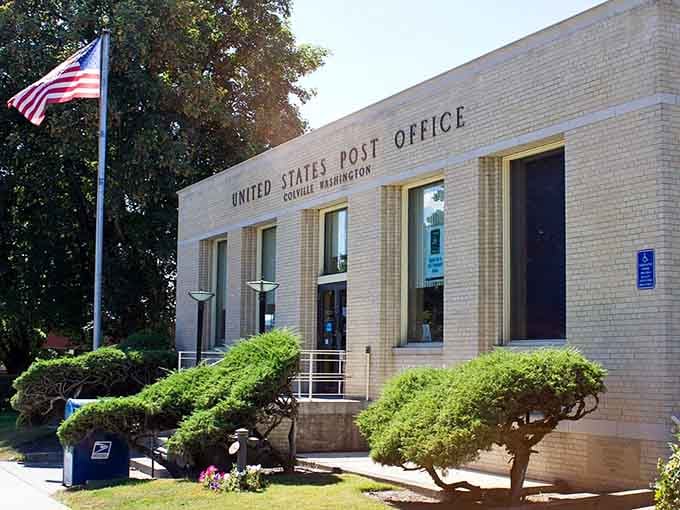 That classic post office building with manicured shrubs represents when government architecture had dignity and stamps cost reasonable amounts.