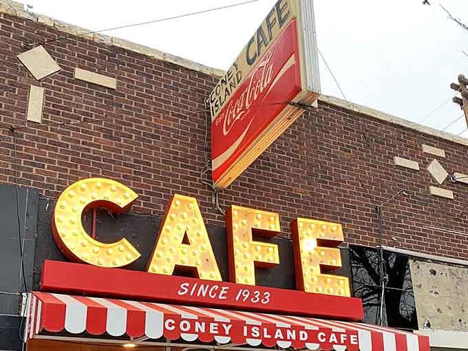 Those marquee-style bulbs spelling "CAFE" light up like a Broadway show for Coney Island dogs and nostalgia.
