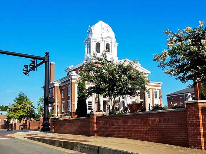 That gleaming white courthouse dome catches the sunlight like a beacon, symbolizing civic pride that's been polished and preserved for generations.