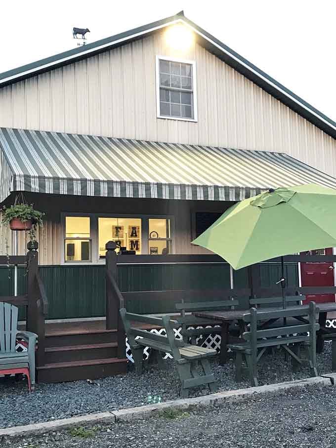 The striped awning and green umbrella create a charming porch scene that invites you to slow down and savor.
