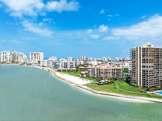Emerald waters lap against manicured shores where island living means balancing nature with modern comfort perfectly.