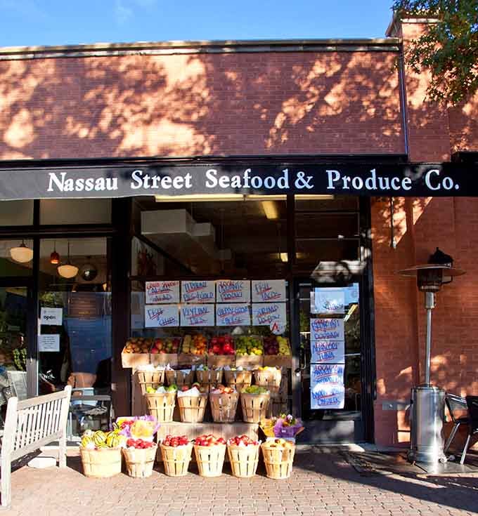 Afternoon light dances across baskets of fresh fruit while seafood specials beckon from the windows inside.