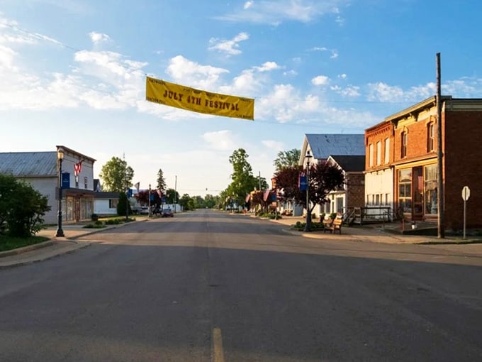 Blue skies and festival banners hint at celebrations that turn this peaceful street into the heart of community gatherings.