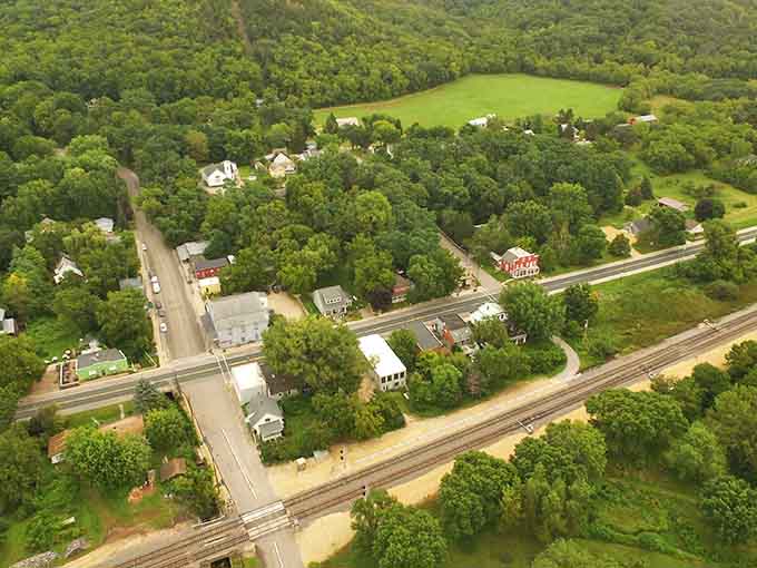 From above, green trees embrace this tiny village like nature's giving it a permanent protective hug.