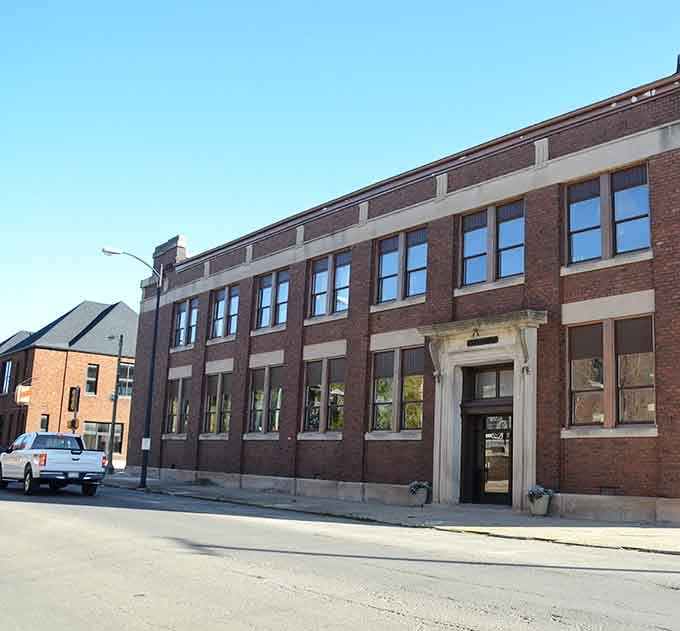 This handsome Streator brick building stands quietly in the morning light, its elegant stone doorway hinting at stories worth knowing.