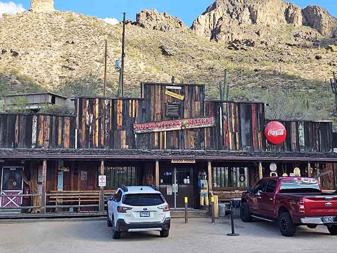 Modern vehicles parked outside this rustic saloon prove some traditions improve rather than fade with time.