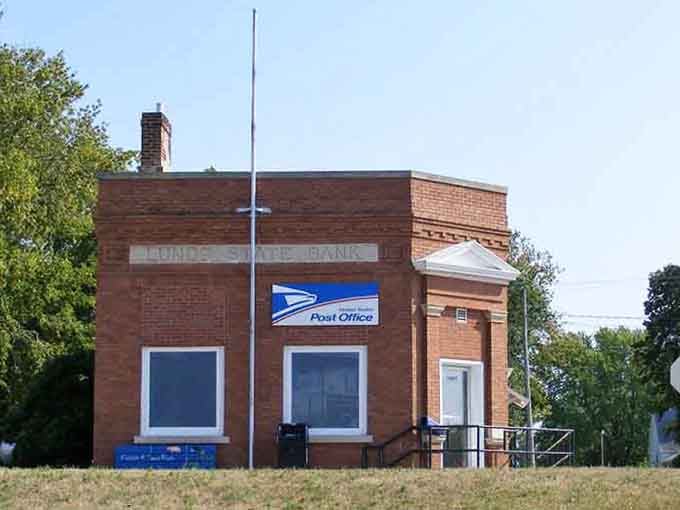 The Lunds State Bank facade now proudly wears a postal service sign — proof that good bones never go out of style.