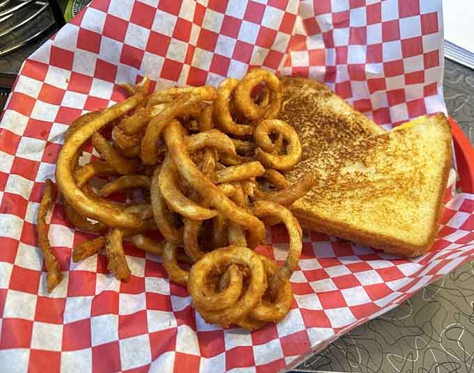 Golden grilled cheese paired with a mountain of crispy curly fries is comfort food that doesn't need fancy explanations.
