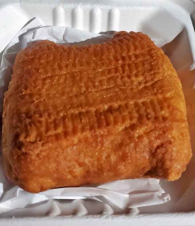 Golden, crispy, and perfectly formed, this knish is comfort food doing its very best work in a styrofoam box.