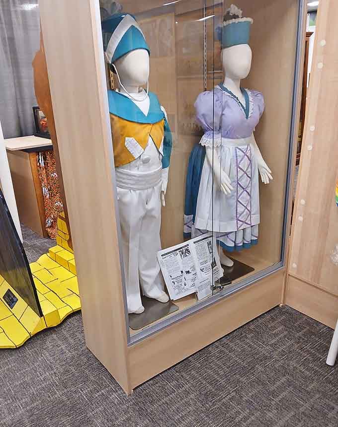 Munchkin costumes preserved behind glass remind us that even the smallest characters made the biggest impact on our hearts.