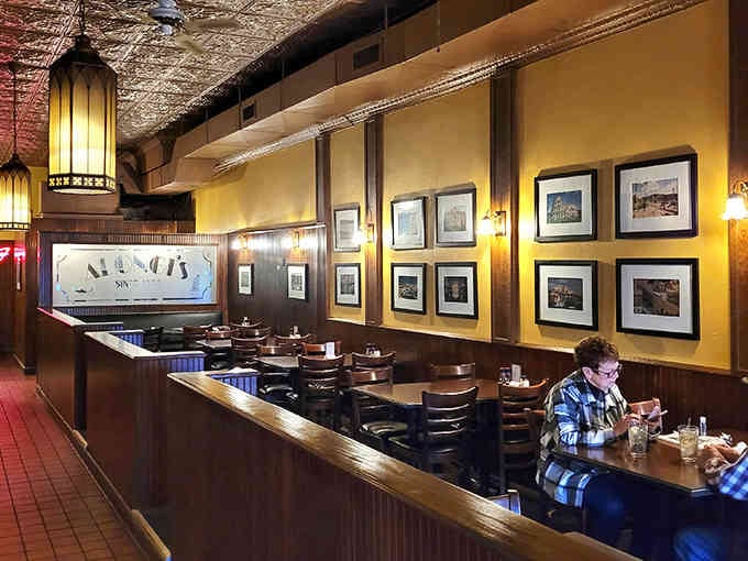 Framed photographs line wood-paneled walls where generations have gathered, creating a living museum of community and connection over meals.