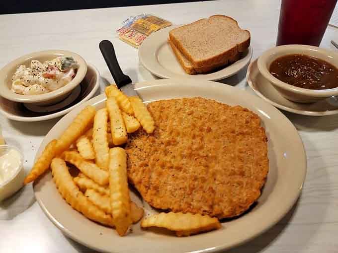 That pork tenderloin is bigger than the plate, breaded and fried to golden glory with all the fixings.