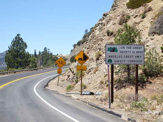 Safety reminders dot the route, gentle nudges to keep your eyes forward despite those distracting views.
