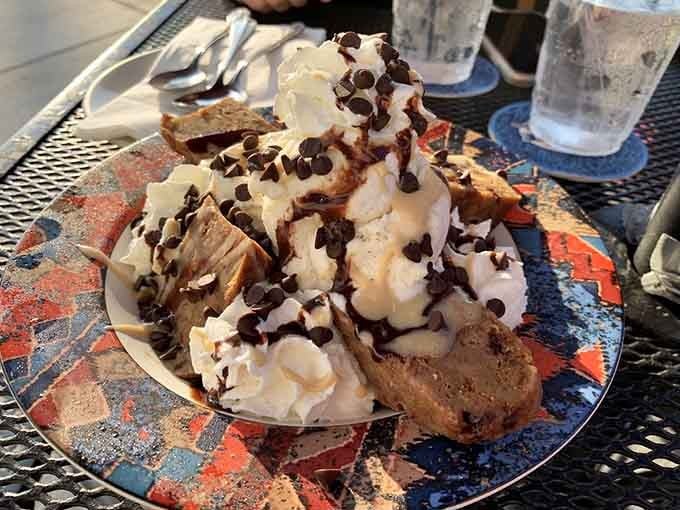 Chocolate bread pudding towers with whipped cream and chocolate chips, a dessert that demands your full attention.