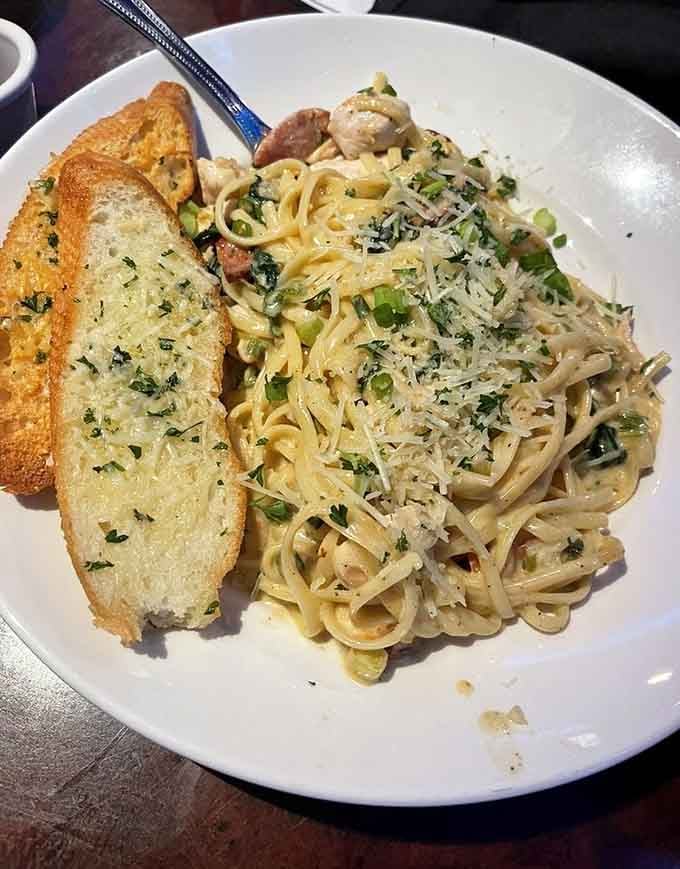Pasta loaded with seafood and served with garlic bread is comfort food that went on a coastal vacation.