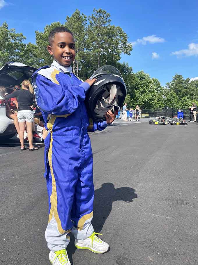 Pure joy radiates from this young racer's smile, proving that speed thrills know absolutely no age limits whatsoever.
