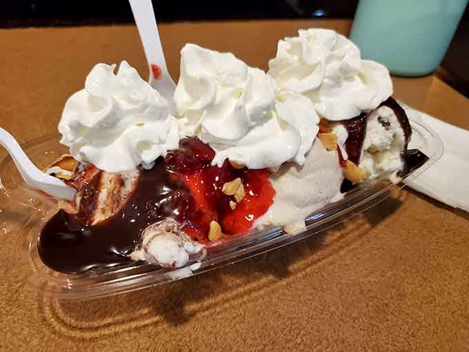 The banana split arrives loaded with toppings, looking like a sundae that went to finishing school and graduated.