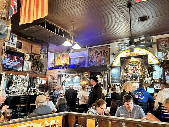 Locals and tourists alike gather under vintage flags and colorful banners, sharing stories over plates of honest-to-goodness good food.