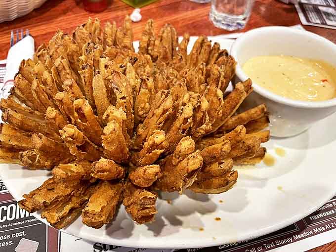 The Blossoming Onion blooms like an edible flower, crispy and golden with a side of dipping sauce for maximum indulgence.